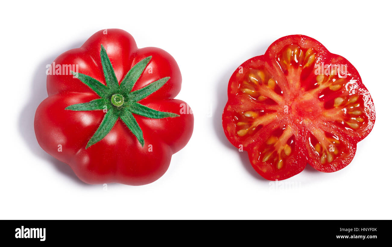 Fresh ripe ribbed heirloom tomato with sepal, whole and half. Top view ...