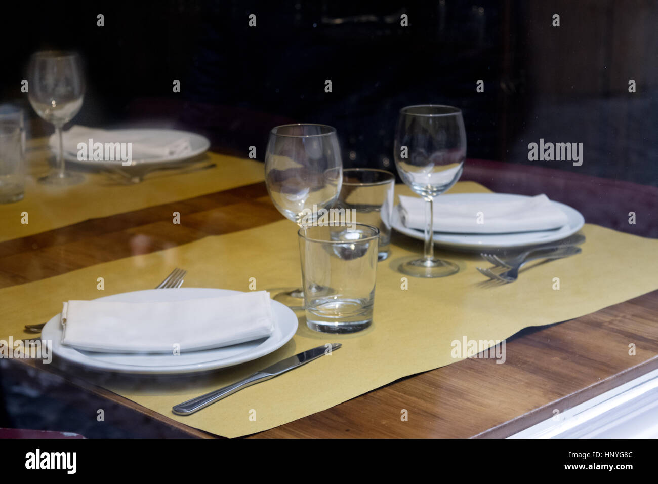 prepared table of a restaurant with cutleries and dishes Stock Photo ...