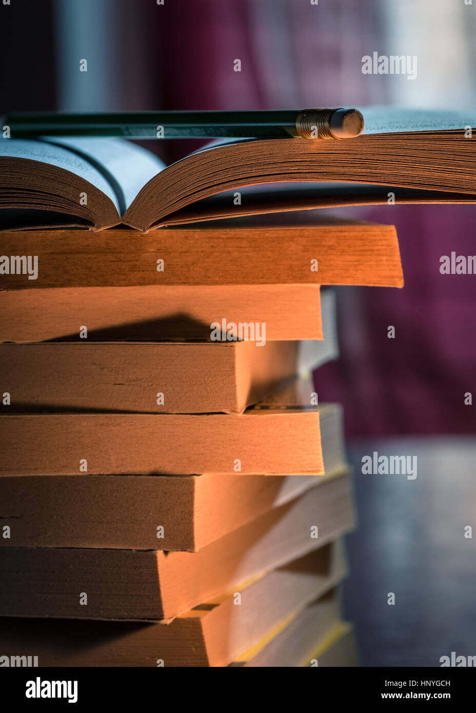 stack of books in the light of the candle Stock Photo - Alamy