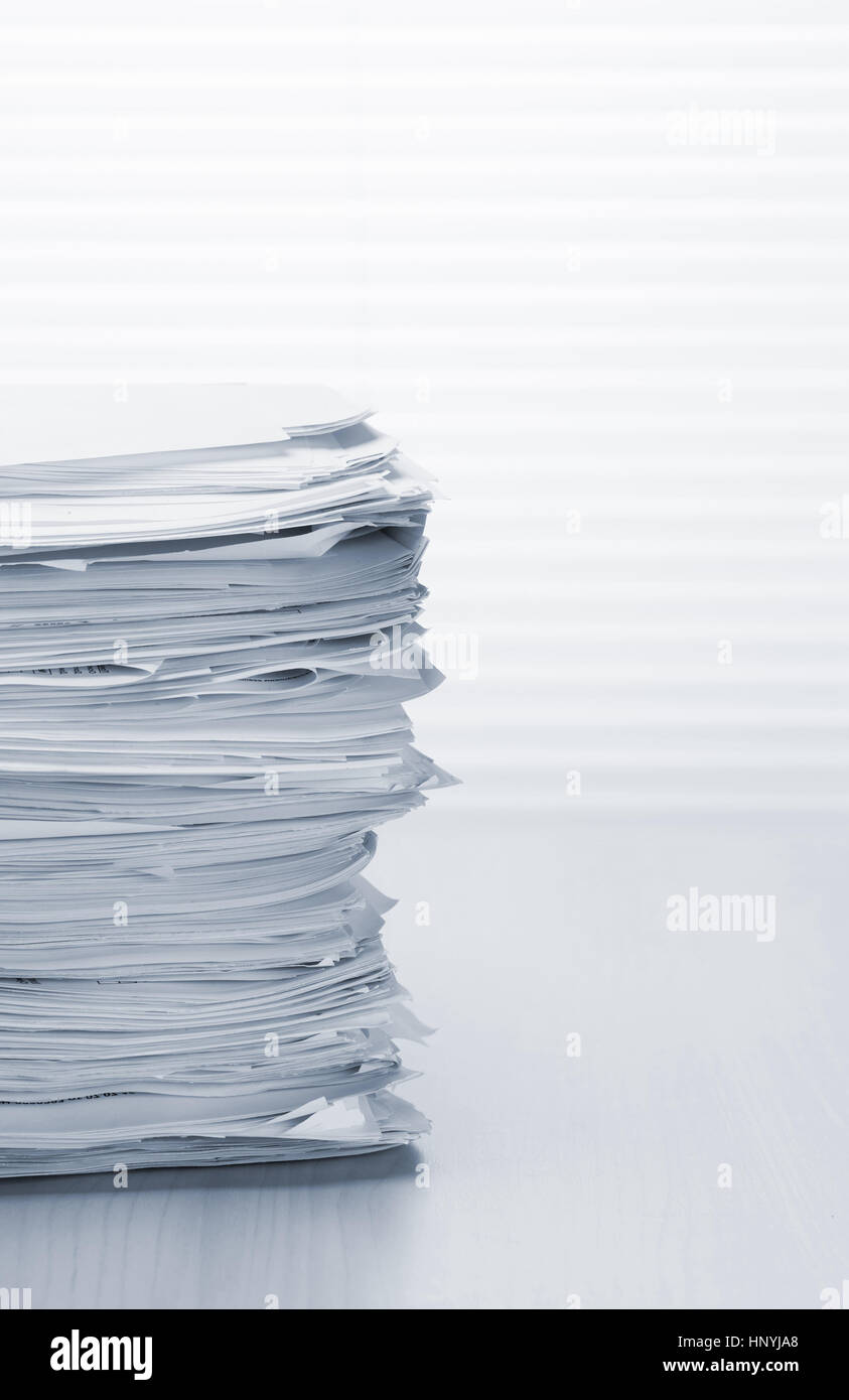 Stack of paper documents on office table. Toned Stock Photo - Alamy