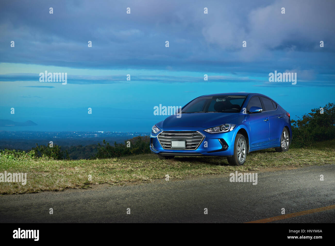 Modern blue sedan car on pretty landscape sunset background Stock Photo ...