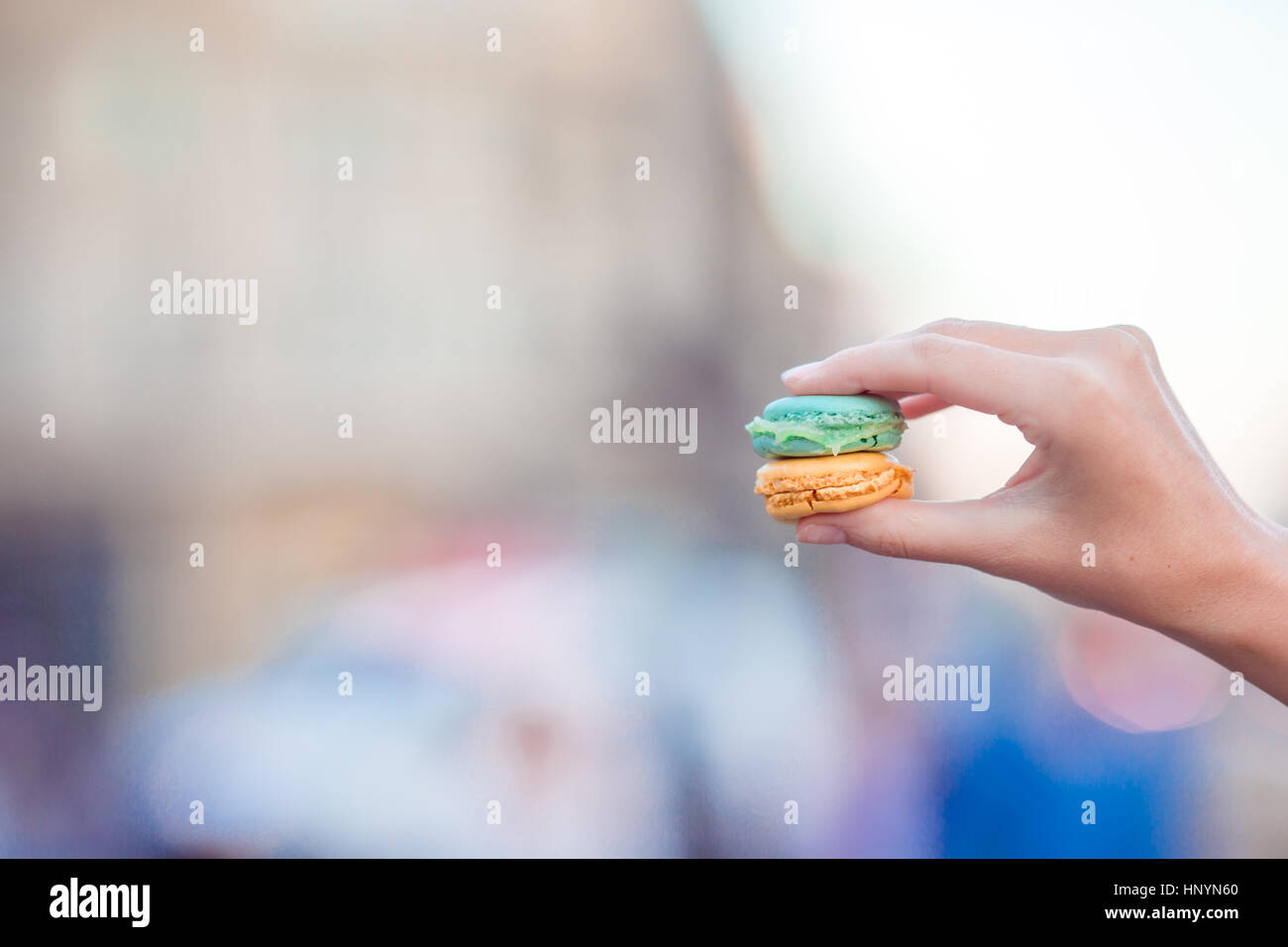 Girl holding colorful French macarons in hands Stock Photo - Alamy