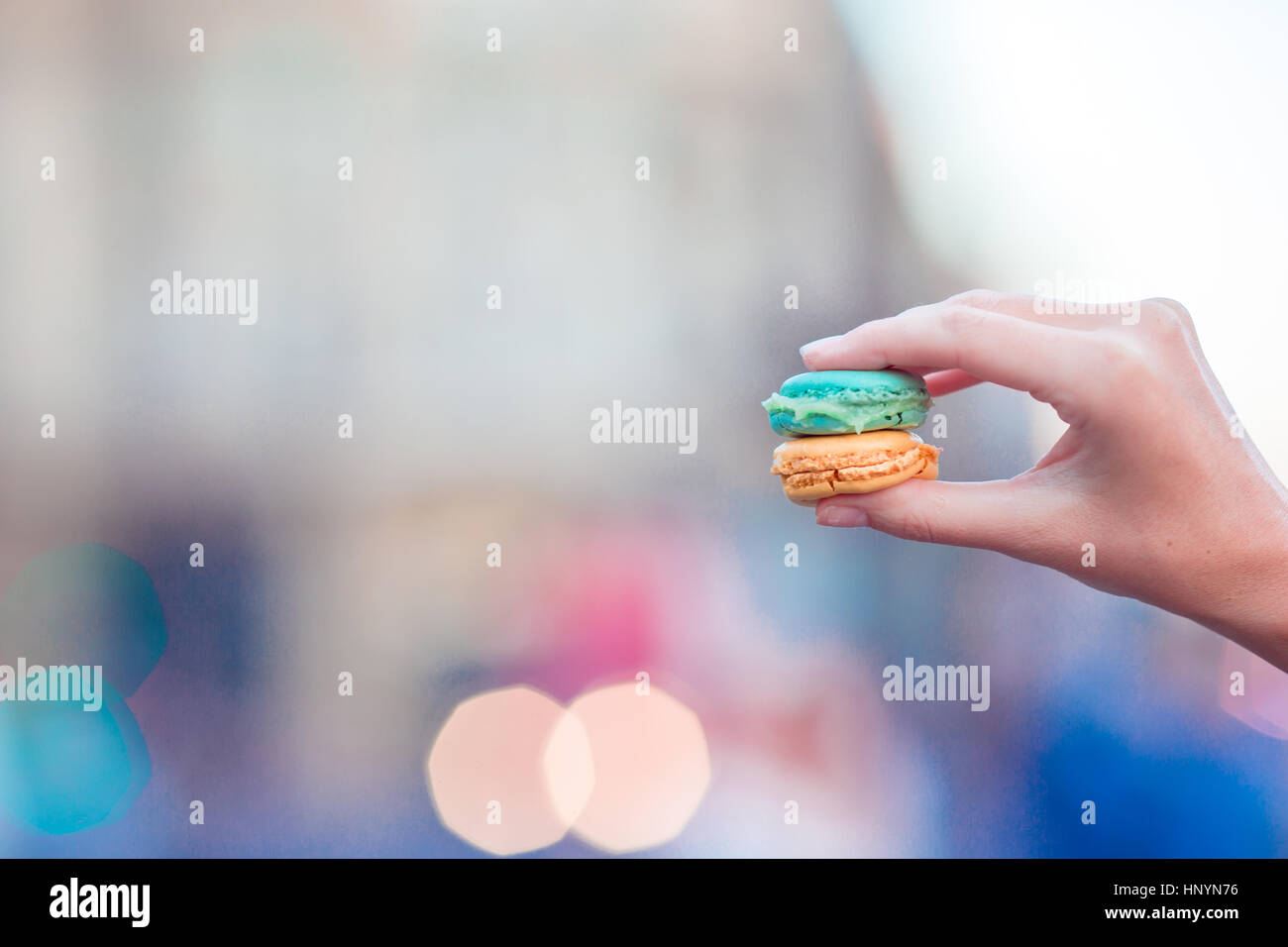 Girl holding colorful French macarons in hands Stock Photo - Alamy