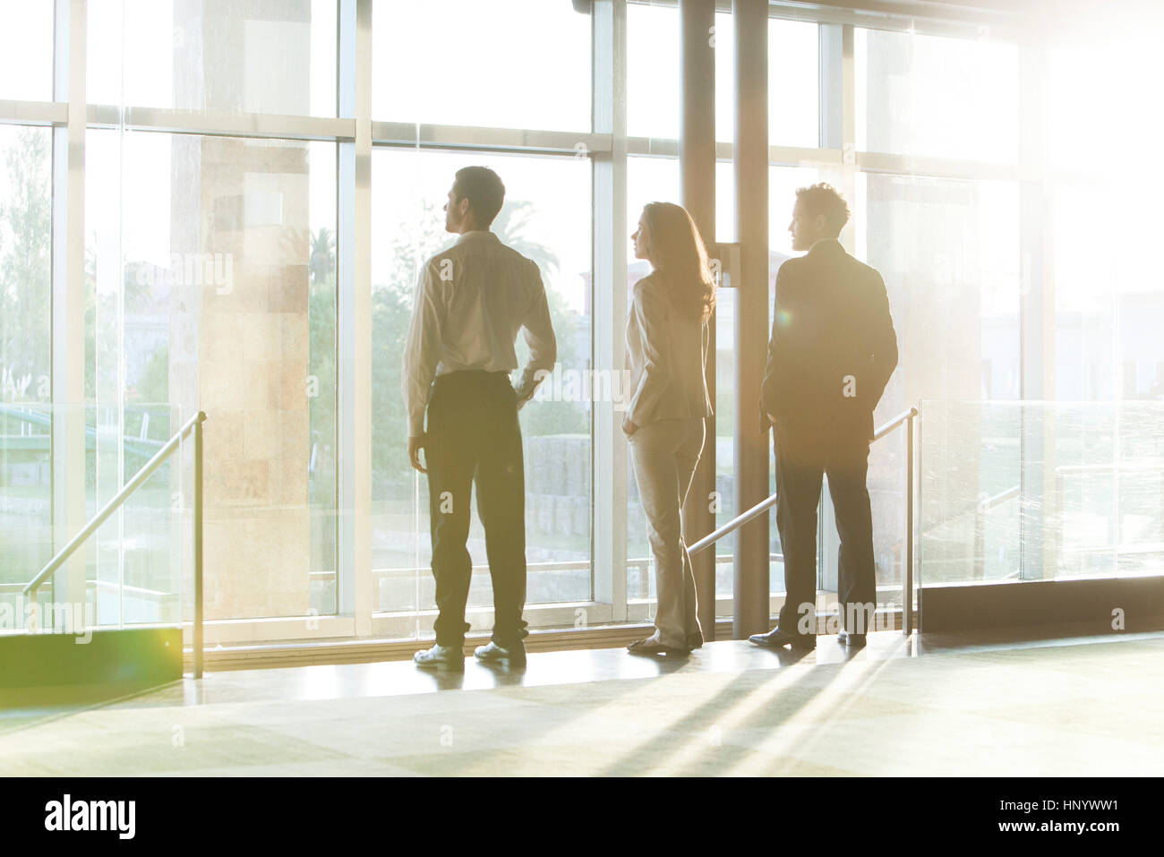 Project team members waiting together at office entrance Stock Photo ...