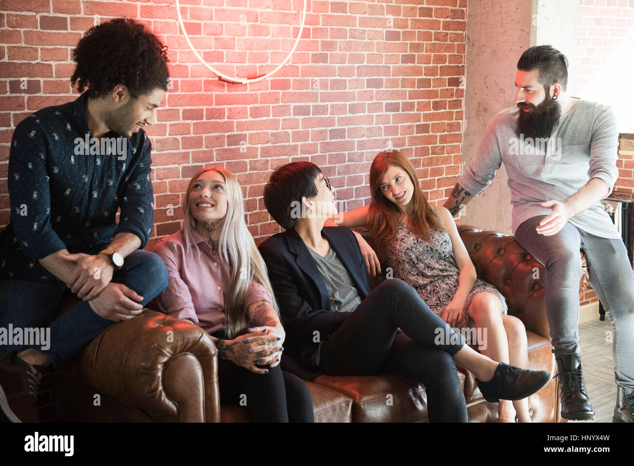 Friends hanging out together on sofa Stock Photo - Alamy