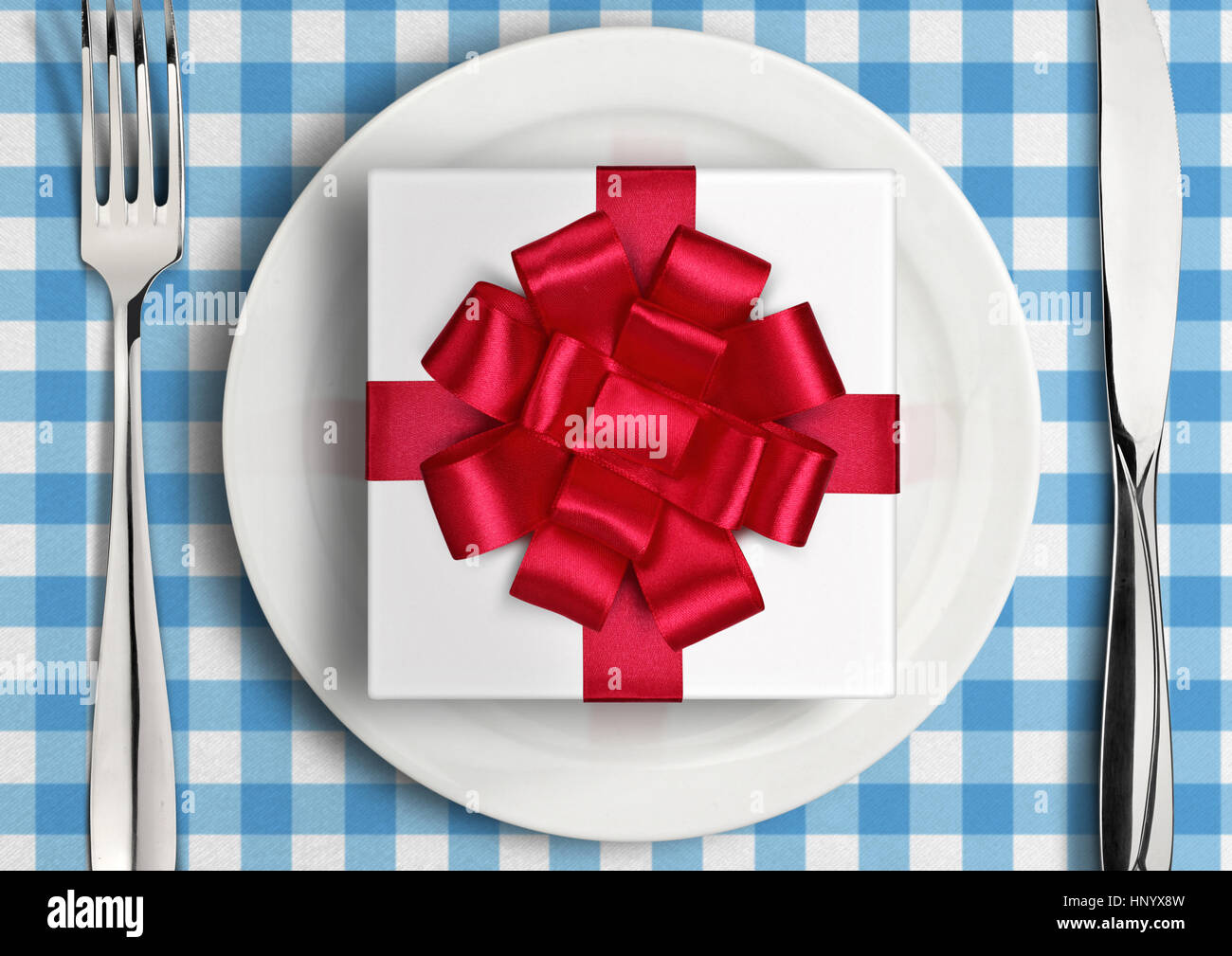 Romantic dinner concept, gift with ribbon on plate Stock Photo - Alamy