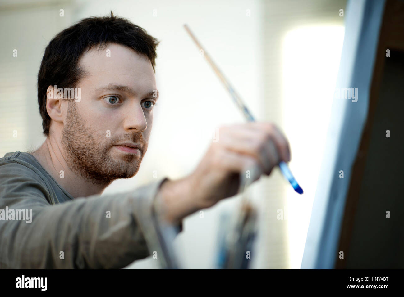 Artist working on oil painting in art studio Stock Photo - Alamy