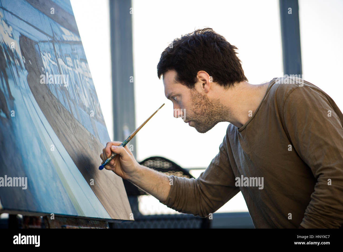 Artist working on oil painting in art studio Stock Photo - Alamy