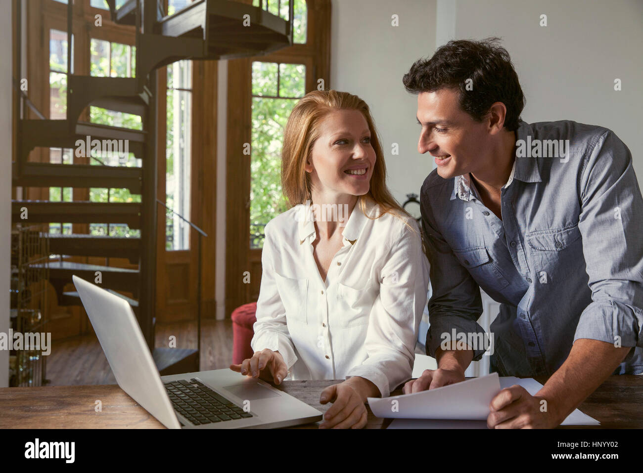 Couple using laptop computer together at home Stock Photo - Alamy