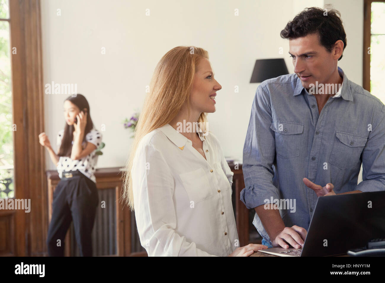 Colleagues talking together in office Stock Photo - Alamy