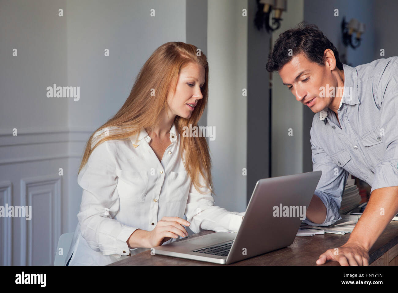 Couple using laptop computer at home Stock Photo - Alamy