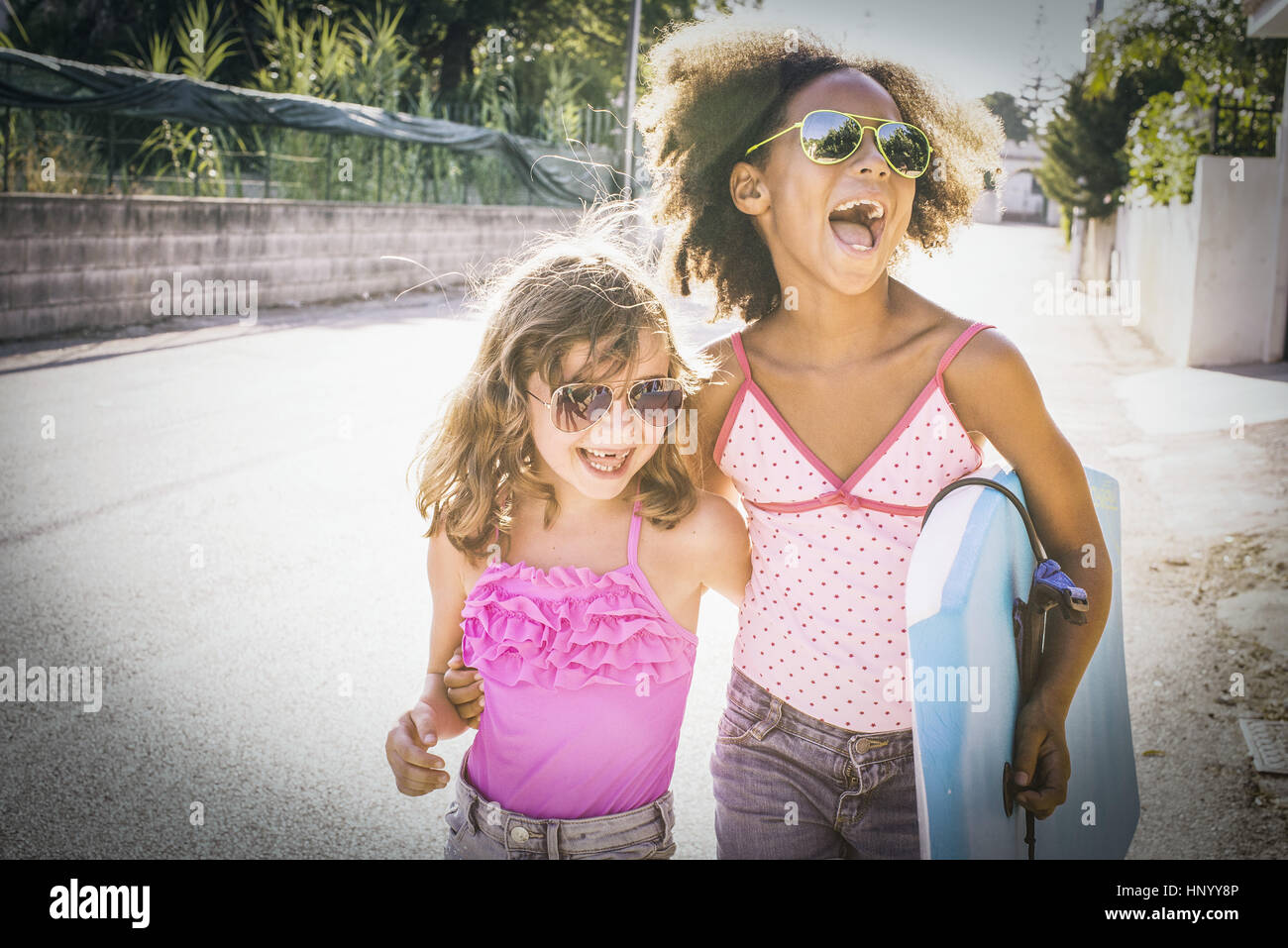 Girls laughing out loud while walking Stock Photo - Alamy