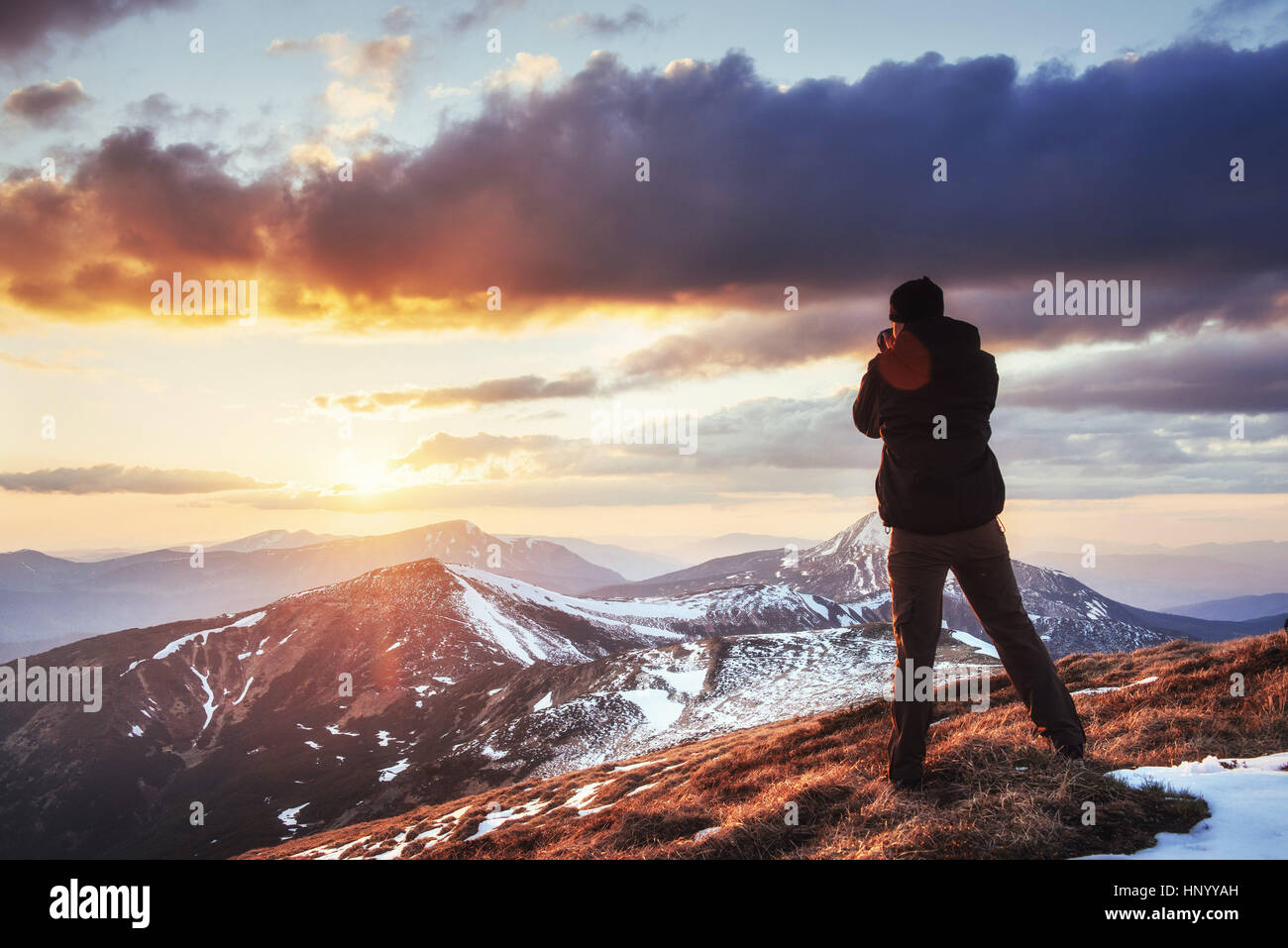tourist looks at the landscape. Beautiful sunset Stock Photo - Alamy
