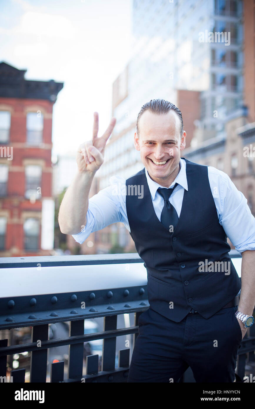 Businessman making peace signs hands hi-res stock photography and ...