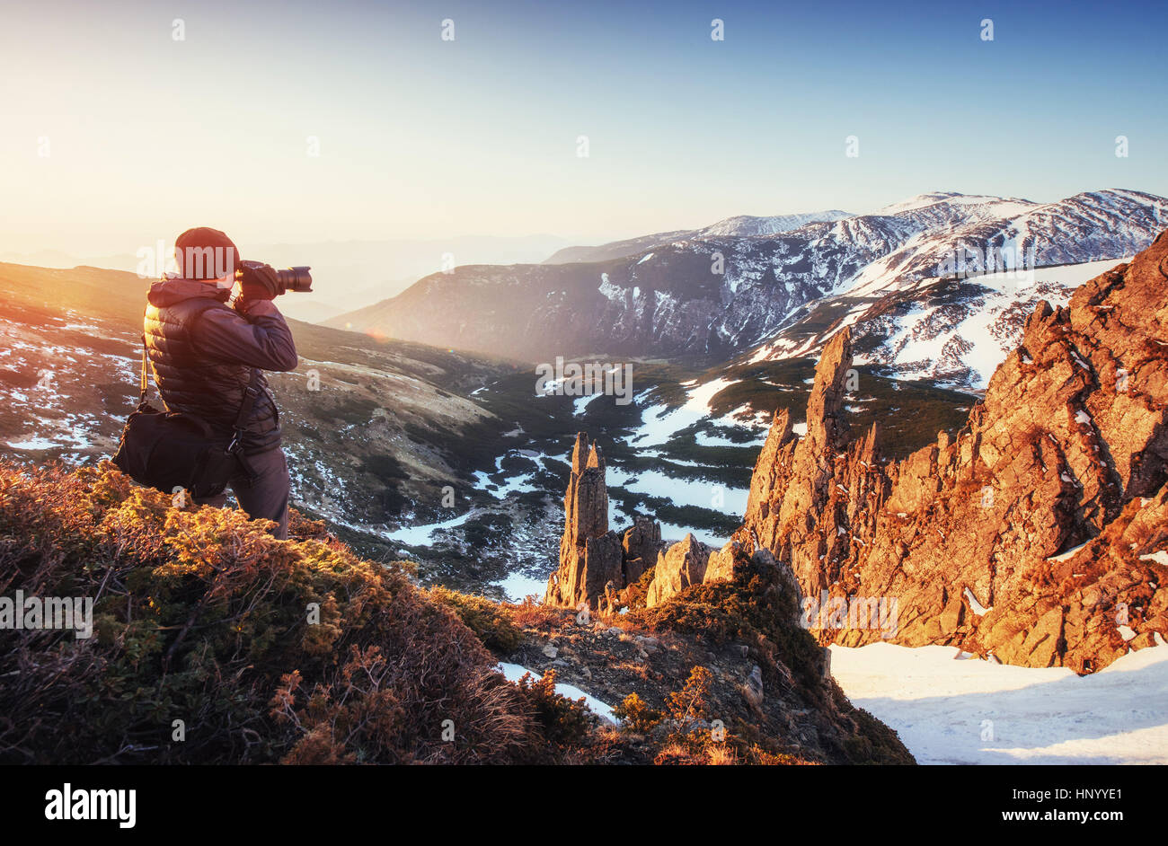 tourist looks at the landscape. Beautiful sunset Stock Photo - Alamy