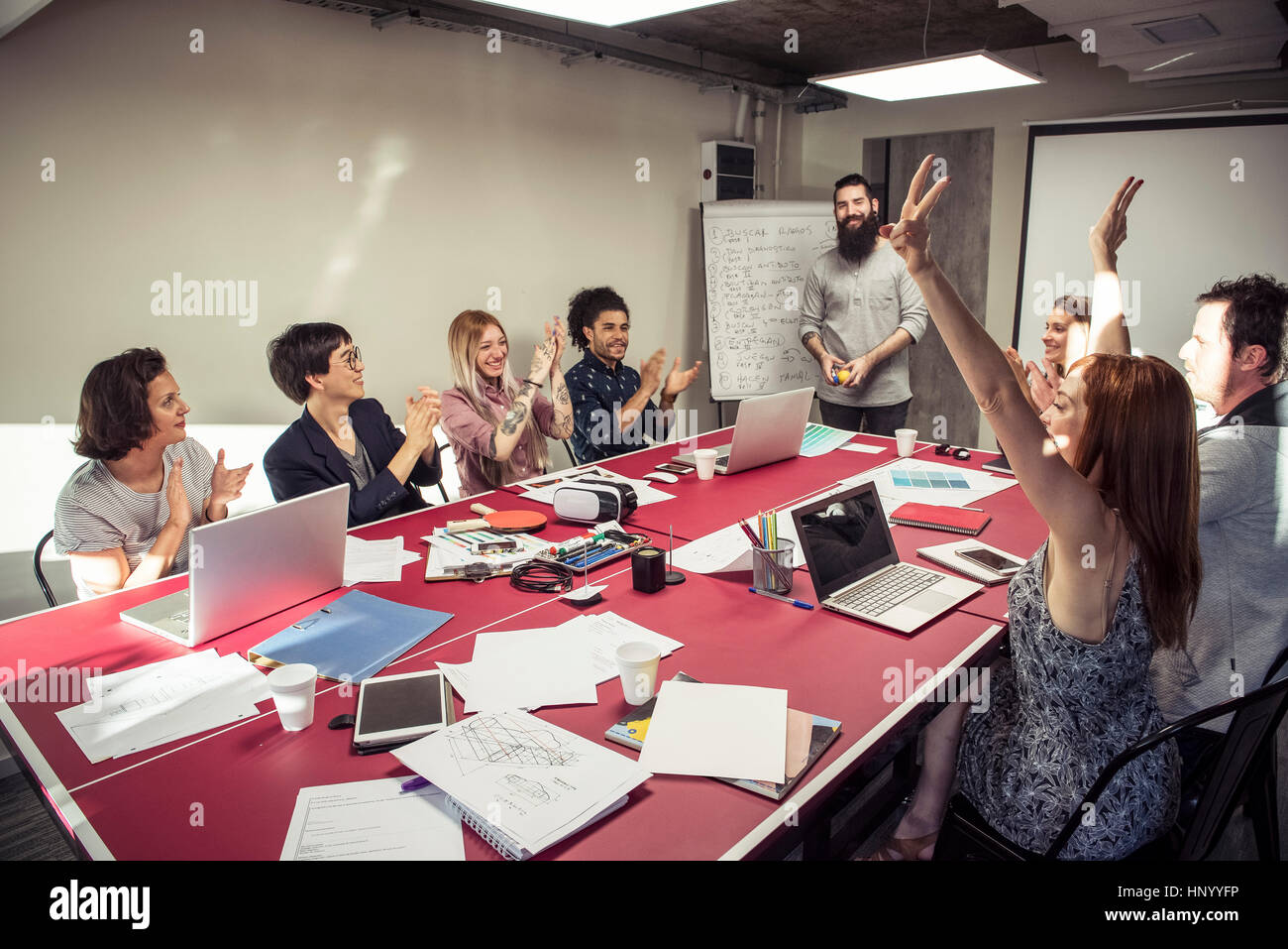 Colleagues celebrating good news during a meeting Stock Photo - Alamy