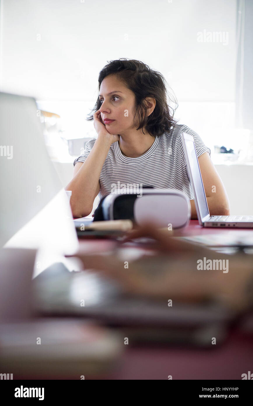 Woman looking bored at work Stock Photo - Alamy