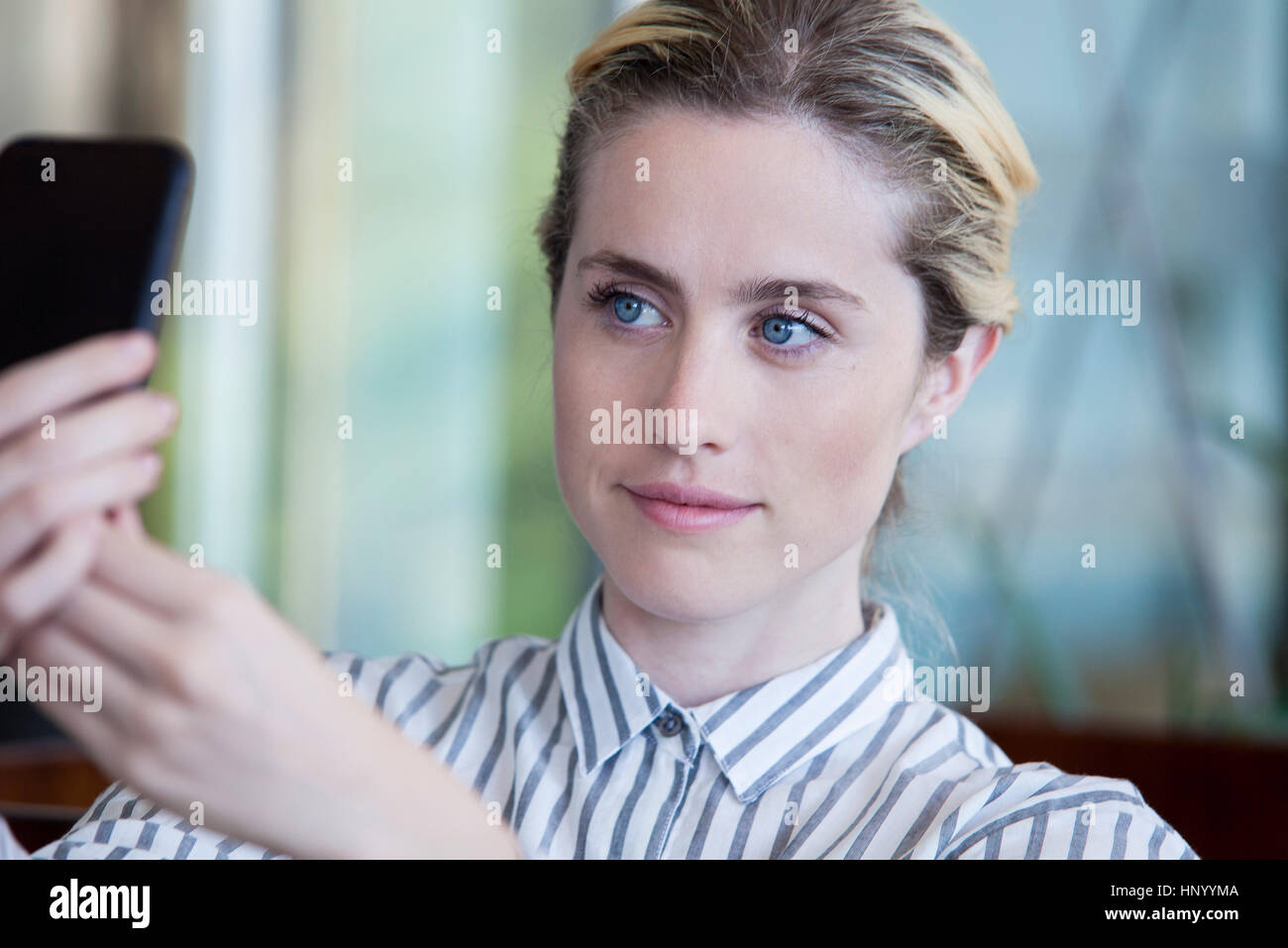 Back view young woman taking photos smartphone hi-res stock photography ...
