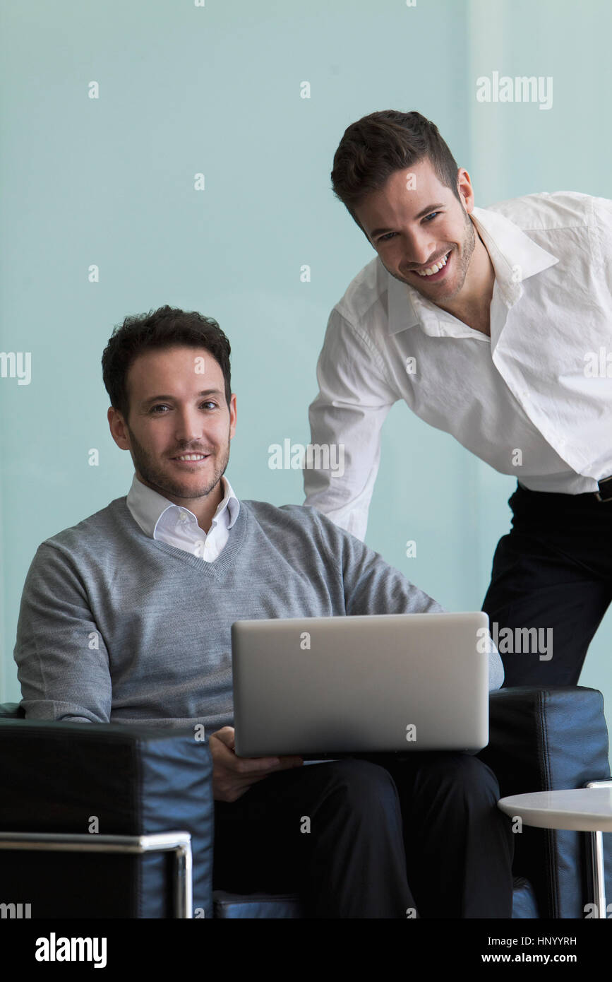 Project team collaborating using laptop computer Stock Photo - Alamy