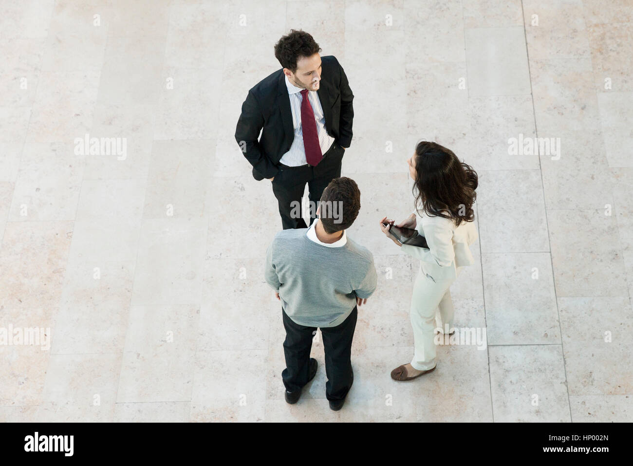 Standing authority face to face communication hands in pockets hi-res ...