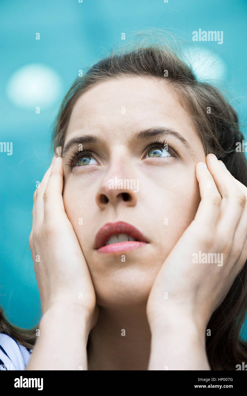 Woman looking up in thought, portrait Stock Photo - Alamy