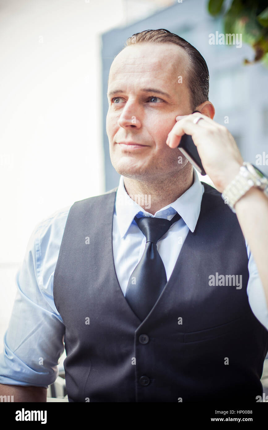 Businessman using cell phone, portrait Stock Photo - Alamy