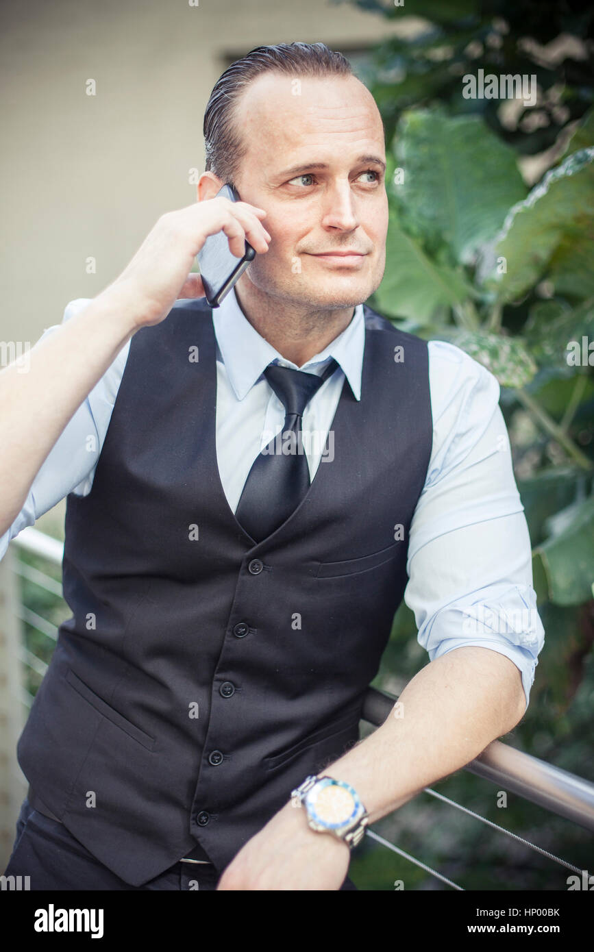 Businessman using cell phone outdoors Stock Photo - Alamy Businessman using cell phone outdoors Stock Photo - Alamy