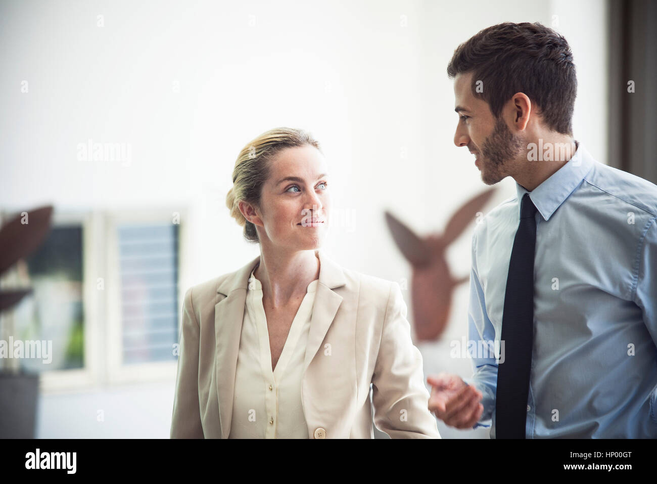 Business colleagues talking together in office Stock Photo - Alamy