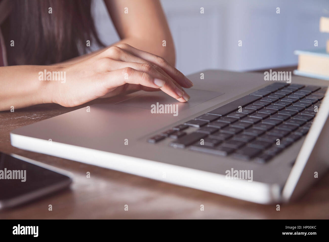 Woman's hand on laptop computer touch pad Stock Photo - Alamy