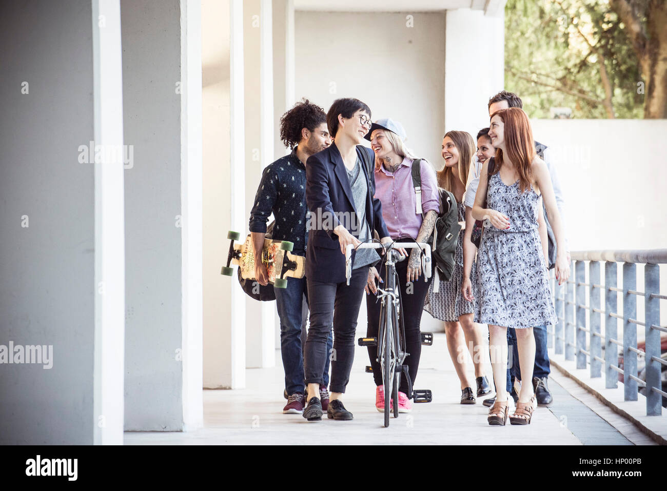 Group of coworkers chatting as they leave the office together Stock ...