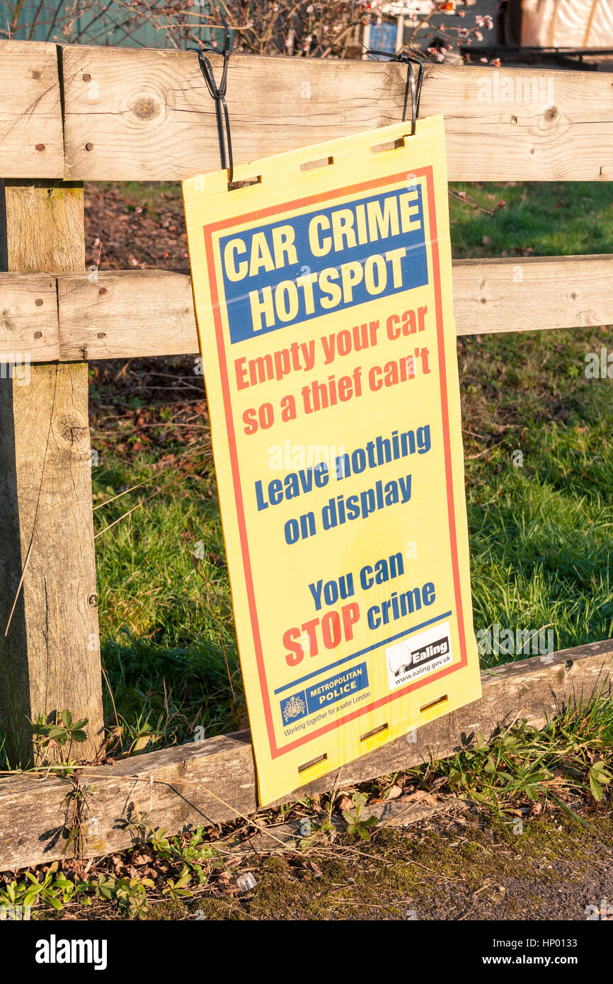 Yellow Metropolitan Police car crime warning sign hanging on a wooden ...