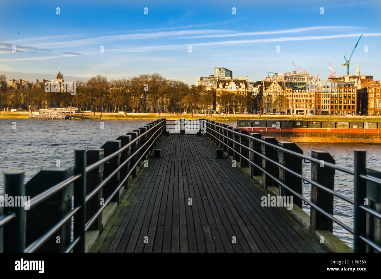 view on the small pier on the river on a sunny day, pier in the city ...