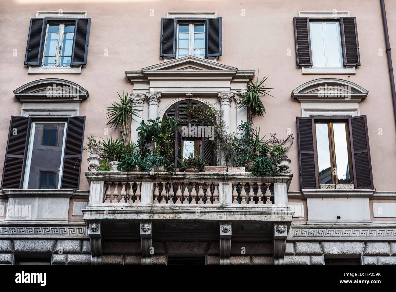 Balcony with plant pots of a classical building in the historical ...