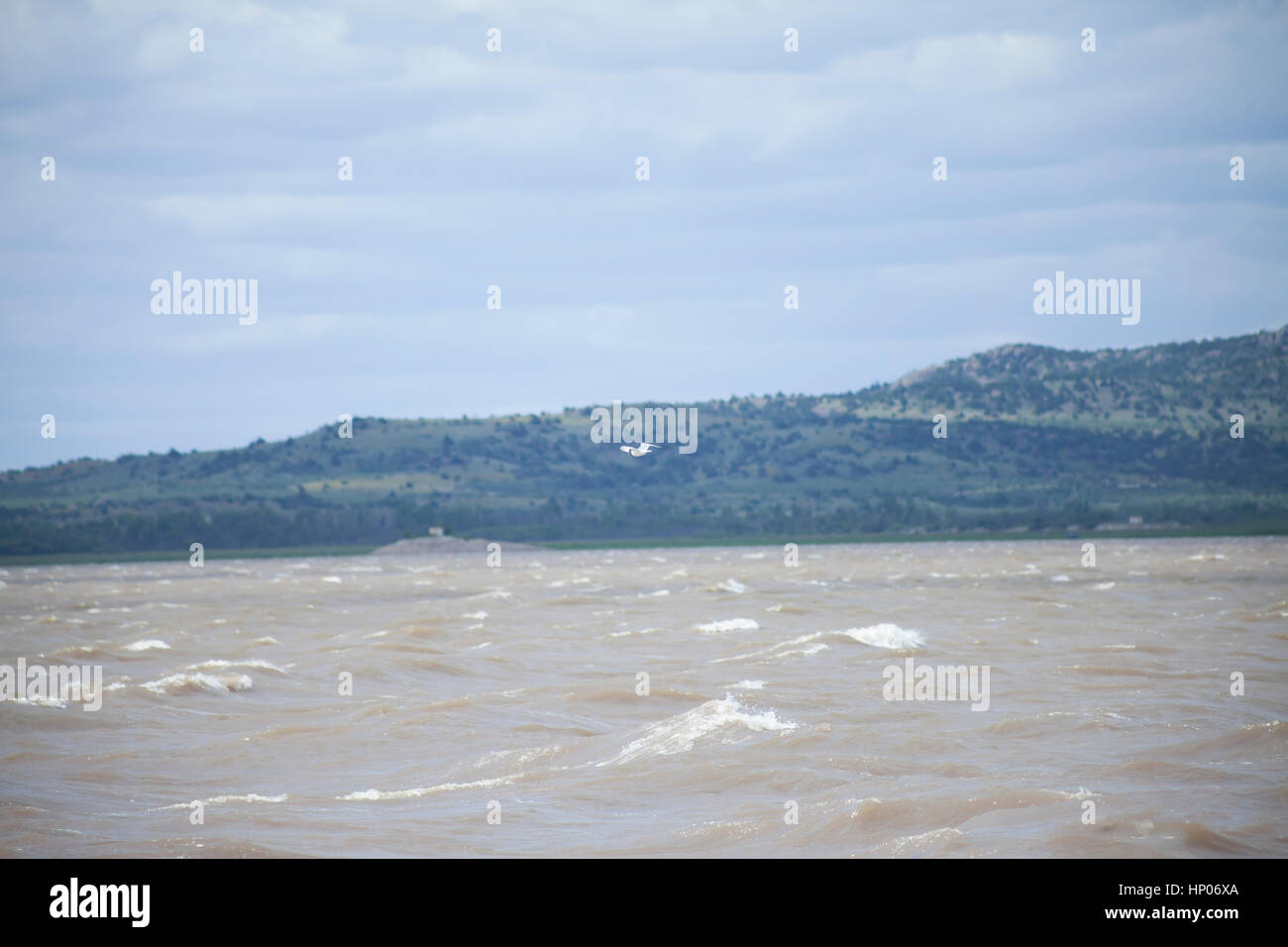 Choppy, brown water at a mountain lake Stock Photo - Alamy