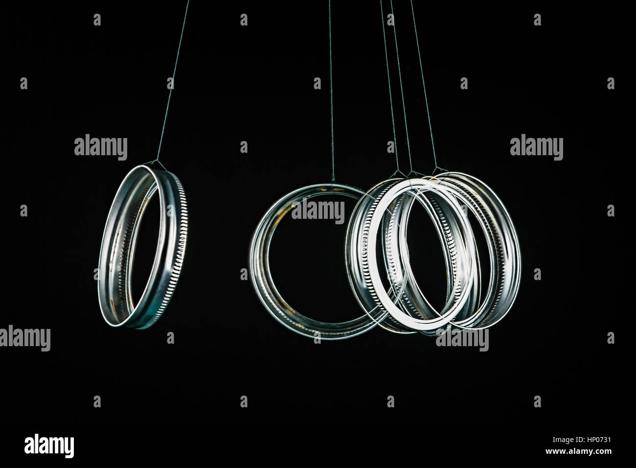 A canning jar lid ring photographed as multiple exposure while swinging ...