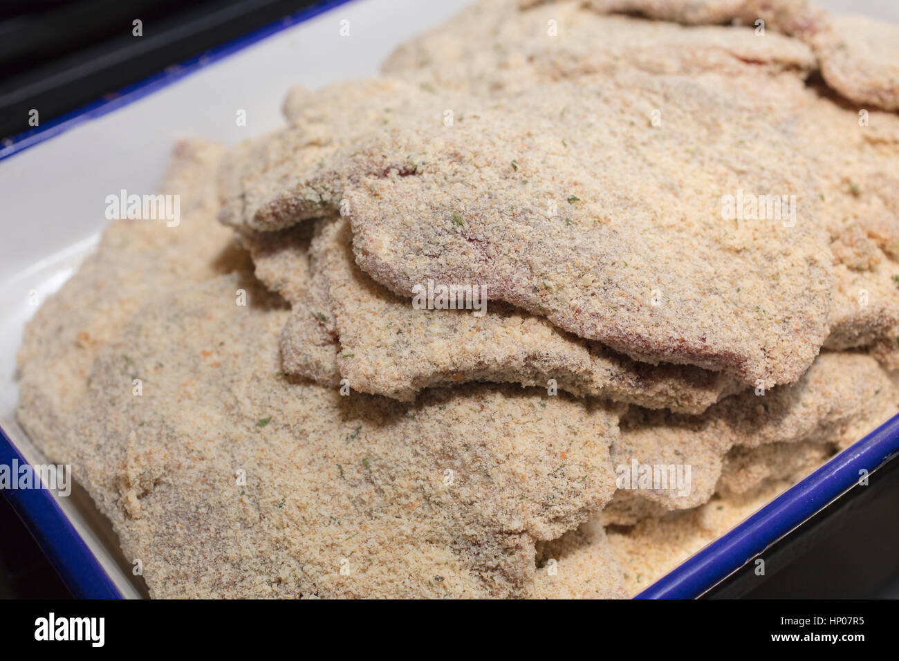 Breaded steaks ready to fry in oil for a dinner meal Stock Photo - Alamy
