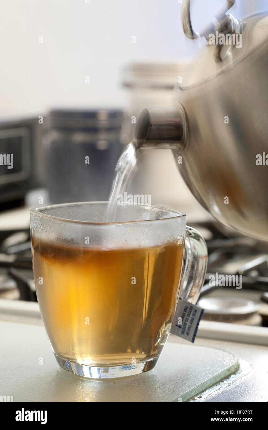 Sequence of pouring water into a glass mug while brewing hot tea Stock ...