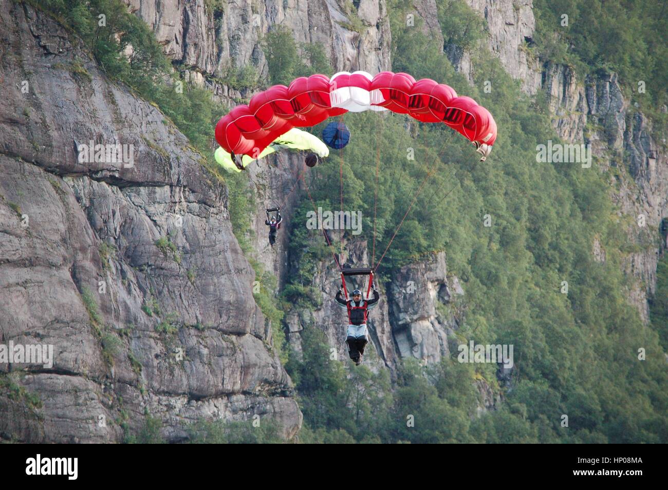 BASE jumpers launching themselves off of the cliffs of Kjerag in ...