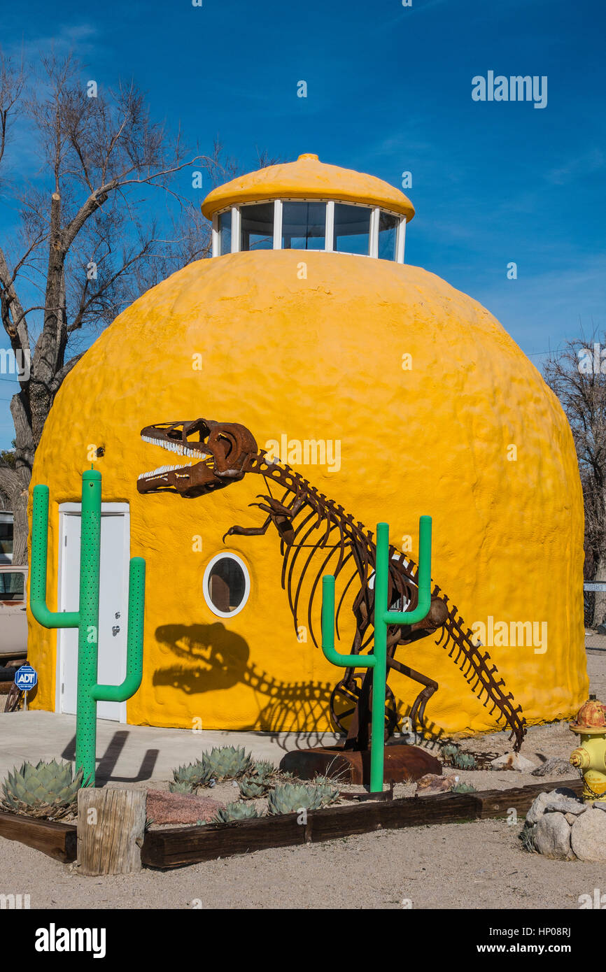 A Yellow Dome structure with green cactus sculptures and a metal ...