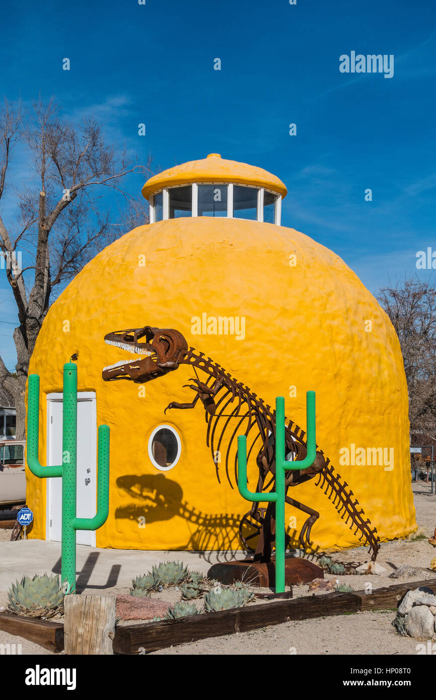 A Yellow Dome structure with green cactus sculptures and a metal ...