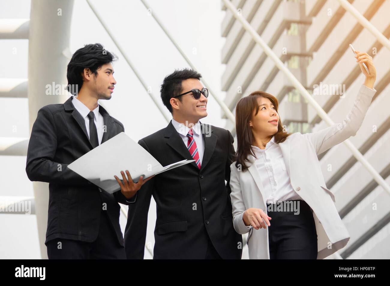 Three business people team making a Selfie outdoor Stock Photo - Alamy