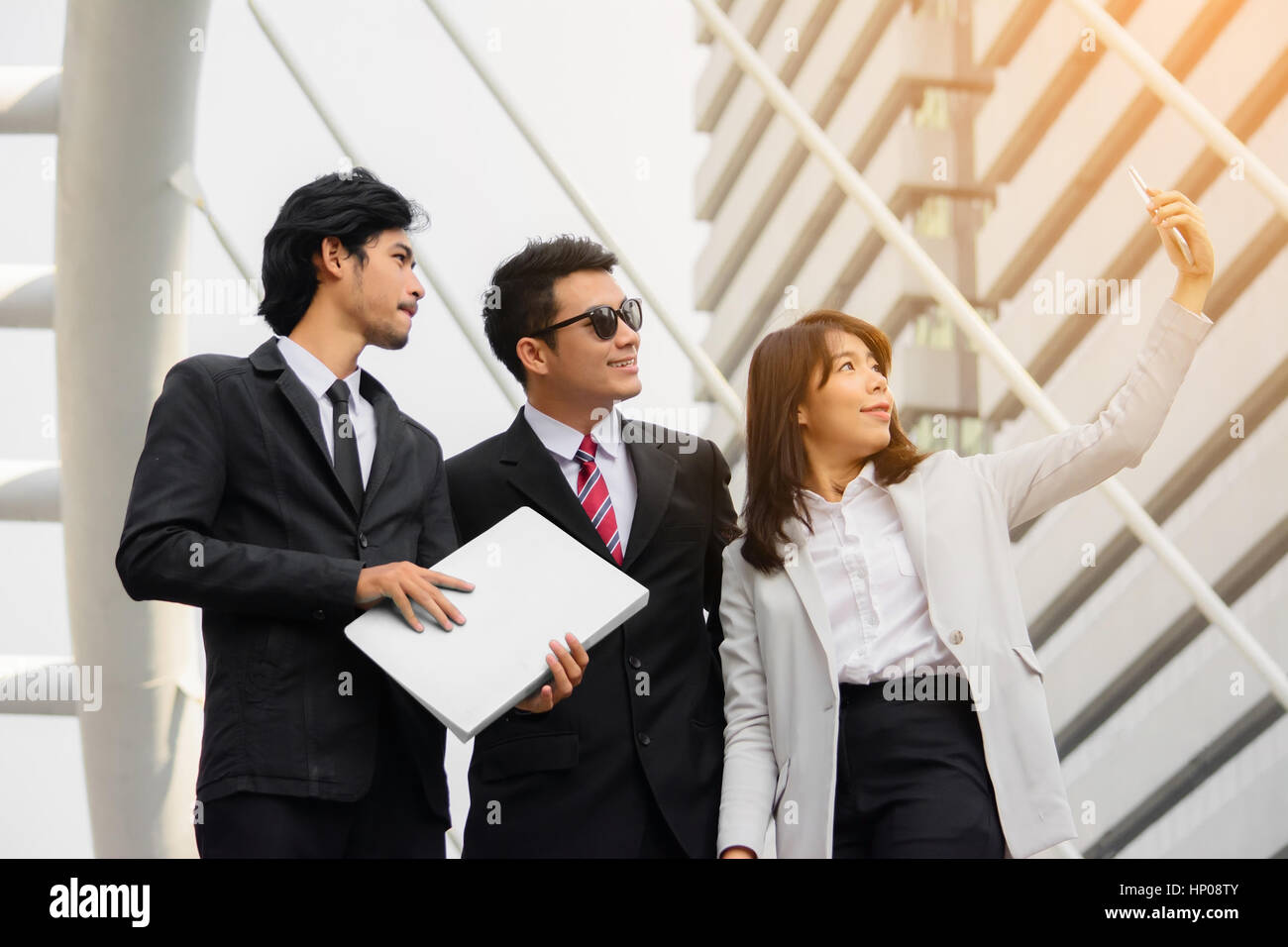 Three business people team making a Selfie outdoor Stock Photo - Alamy