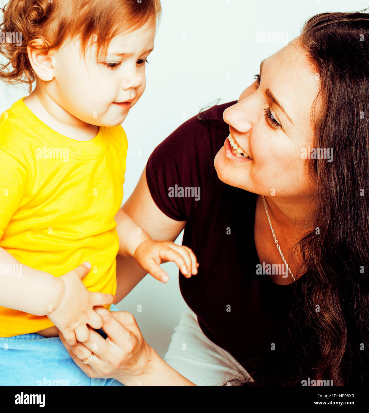pretty real normal mother with cute blond little daughter close up ...