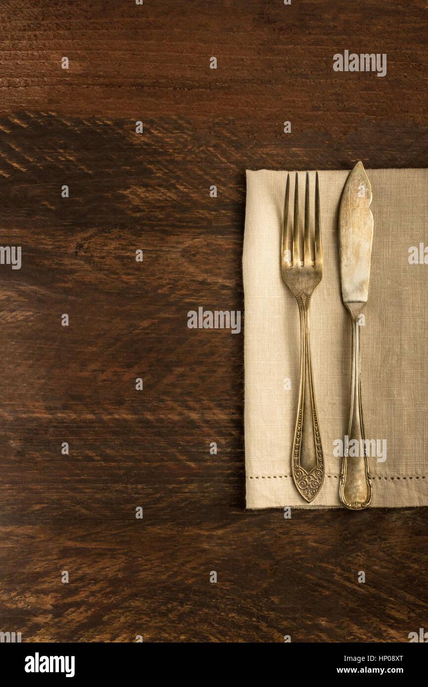 Vintage fork and knife on wooden table with copyspace Stock Photo - Alamy