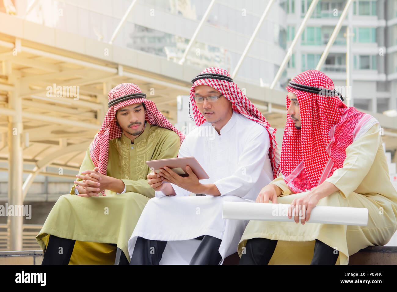 Arab Business people sitting and consultanting by using tablet with ...