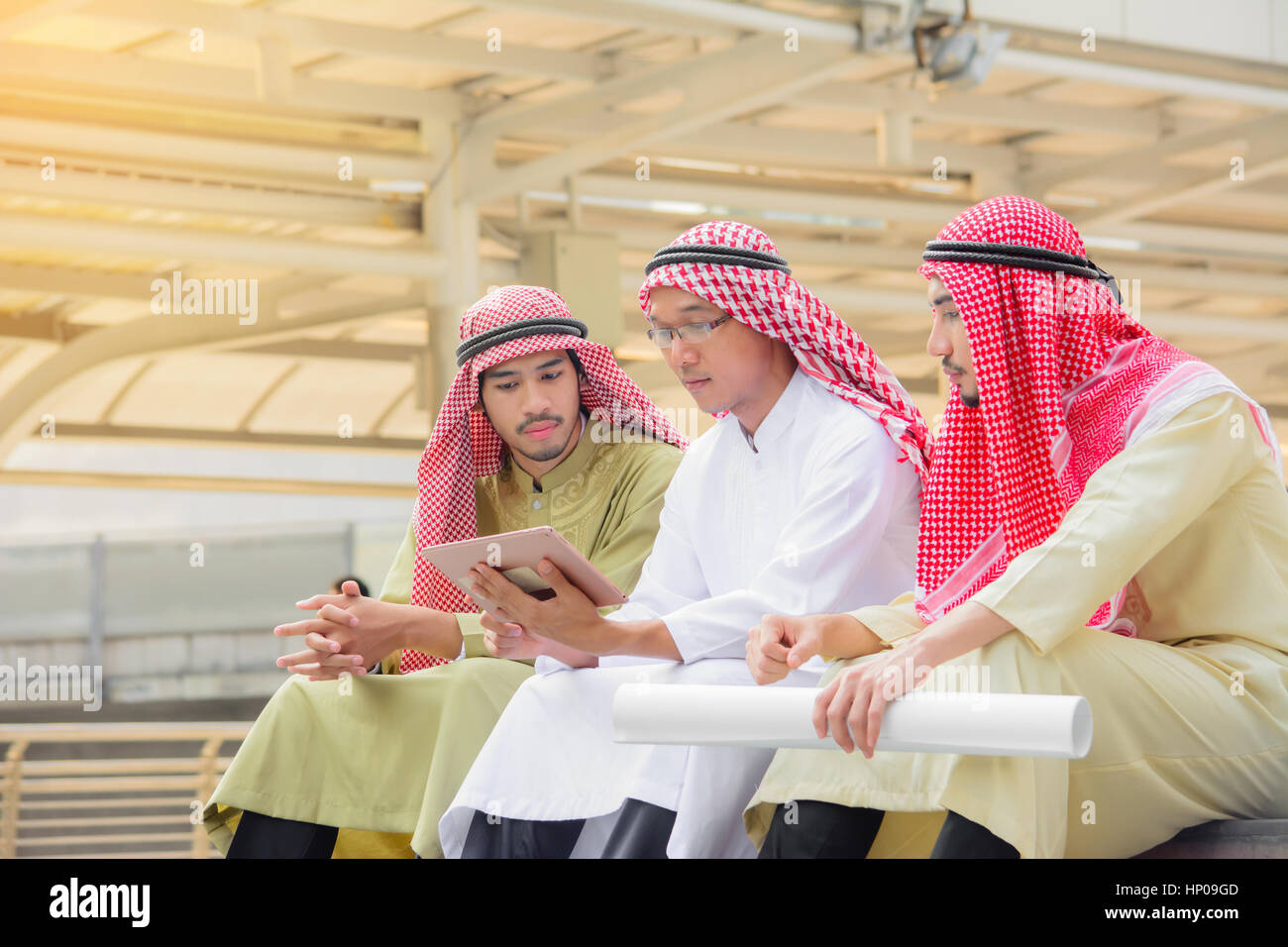 Arab Business people sitting and consultanting by using tablet with ...