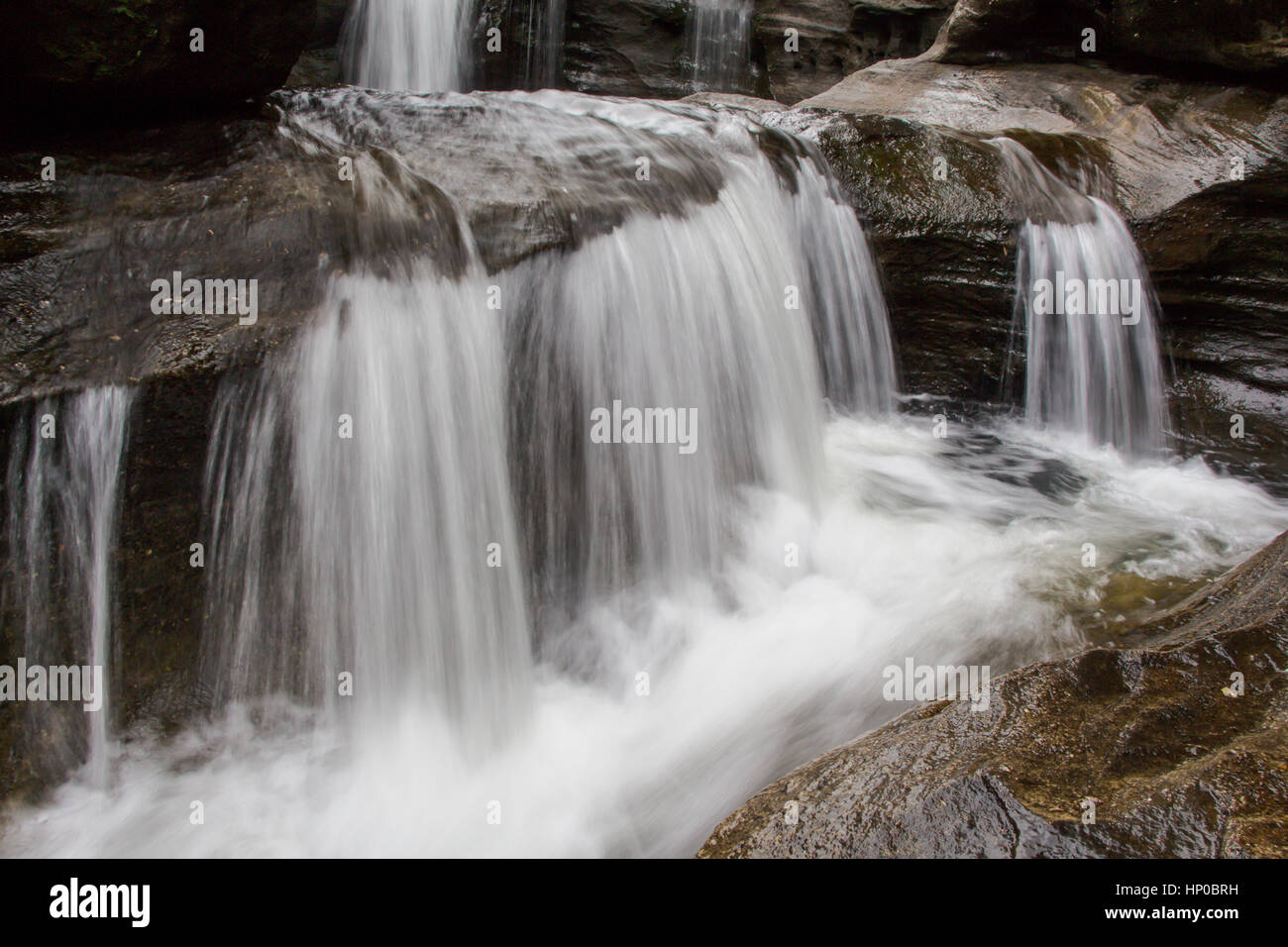 Waterfall with rock Stock Photo - Alamy
