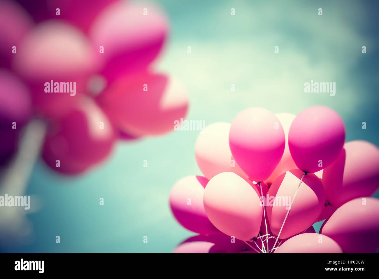 pink balloons and blue sky background Stock Photo - Alamy