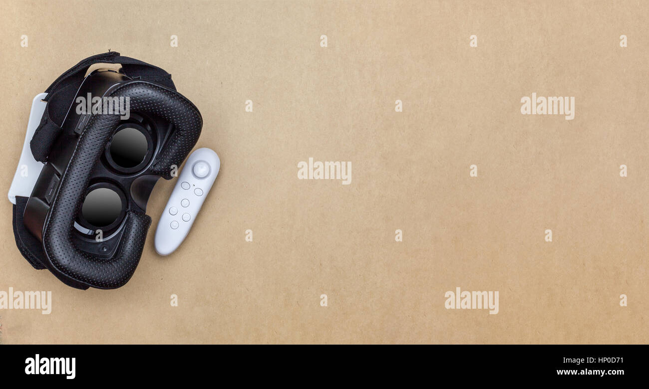 3d virtual glasses and bluetooth joy stick on brown paper background ...