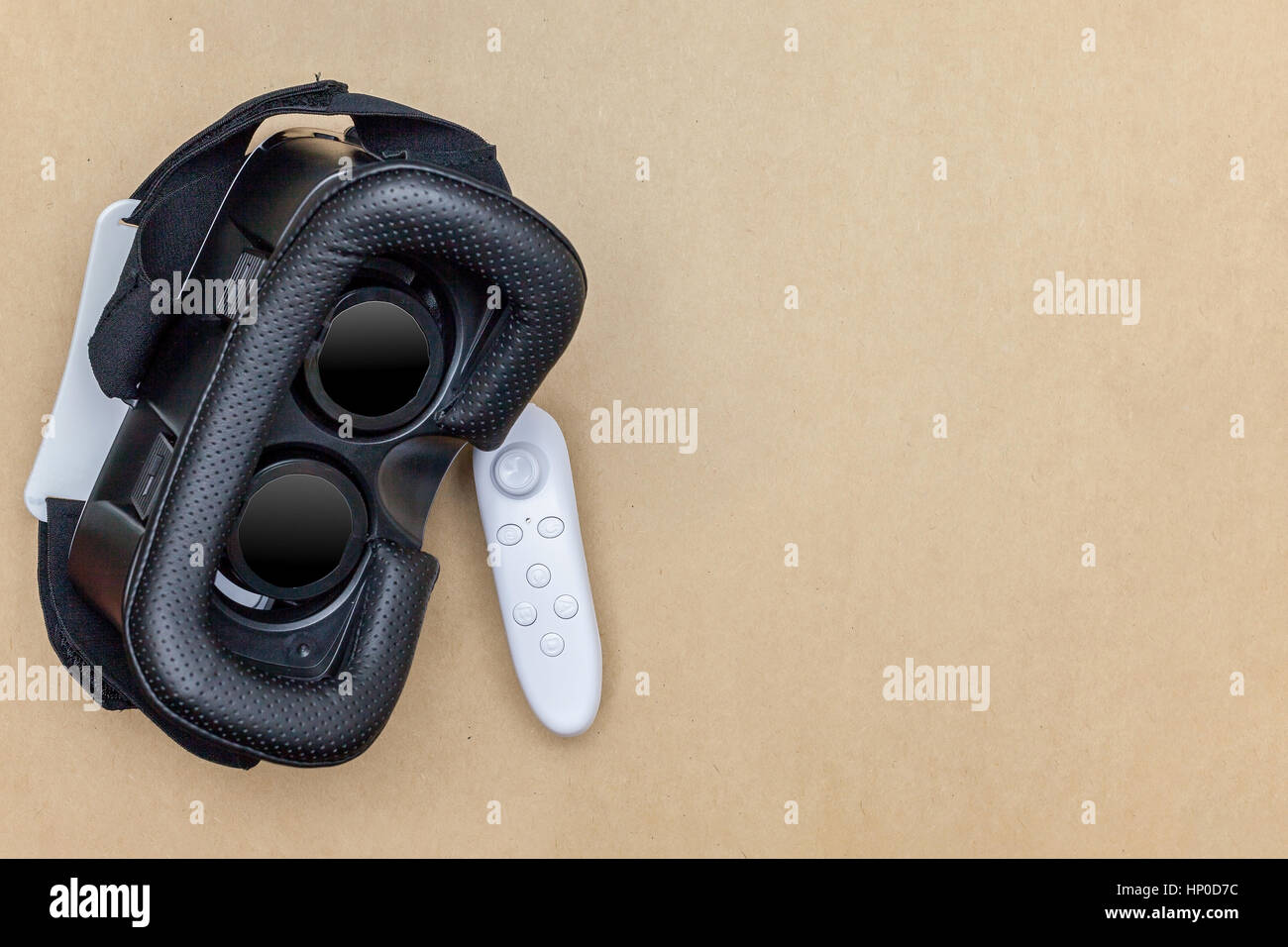 3d virtual glasses and bluetooth joy stick on brown paper background ...